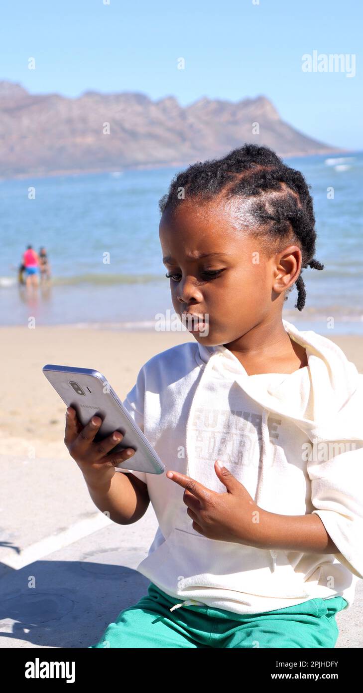 black African boy using a cellphone Stock Photo - Alamy