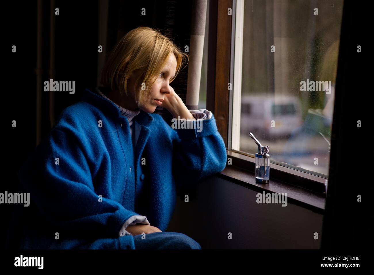 Woman smoking by window hi-res stock photography and images - Alamy