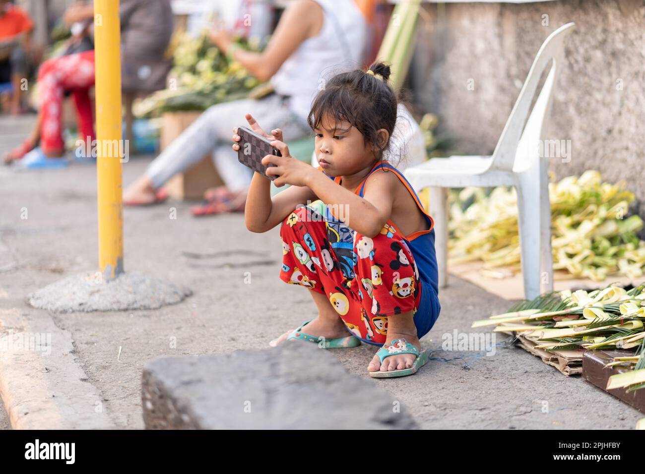 Young child using a mobile phone, Cebu City, Philippines Stock Photo ...