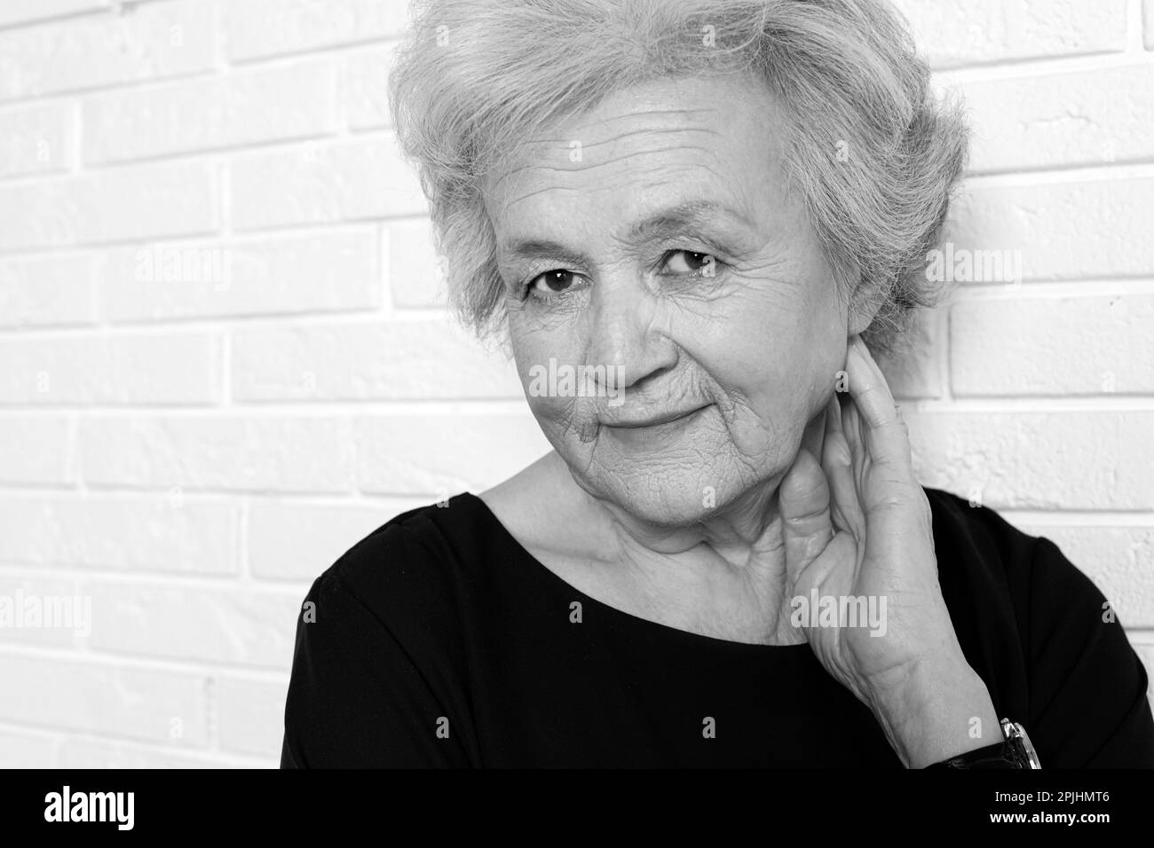 Portrait Of Mature Woman Near Brick Wall Black And White Photography