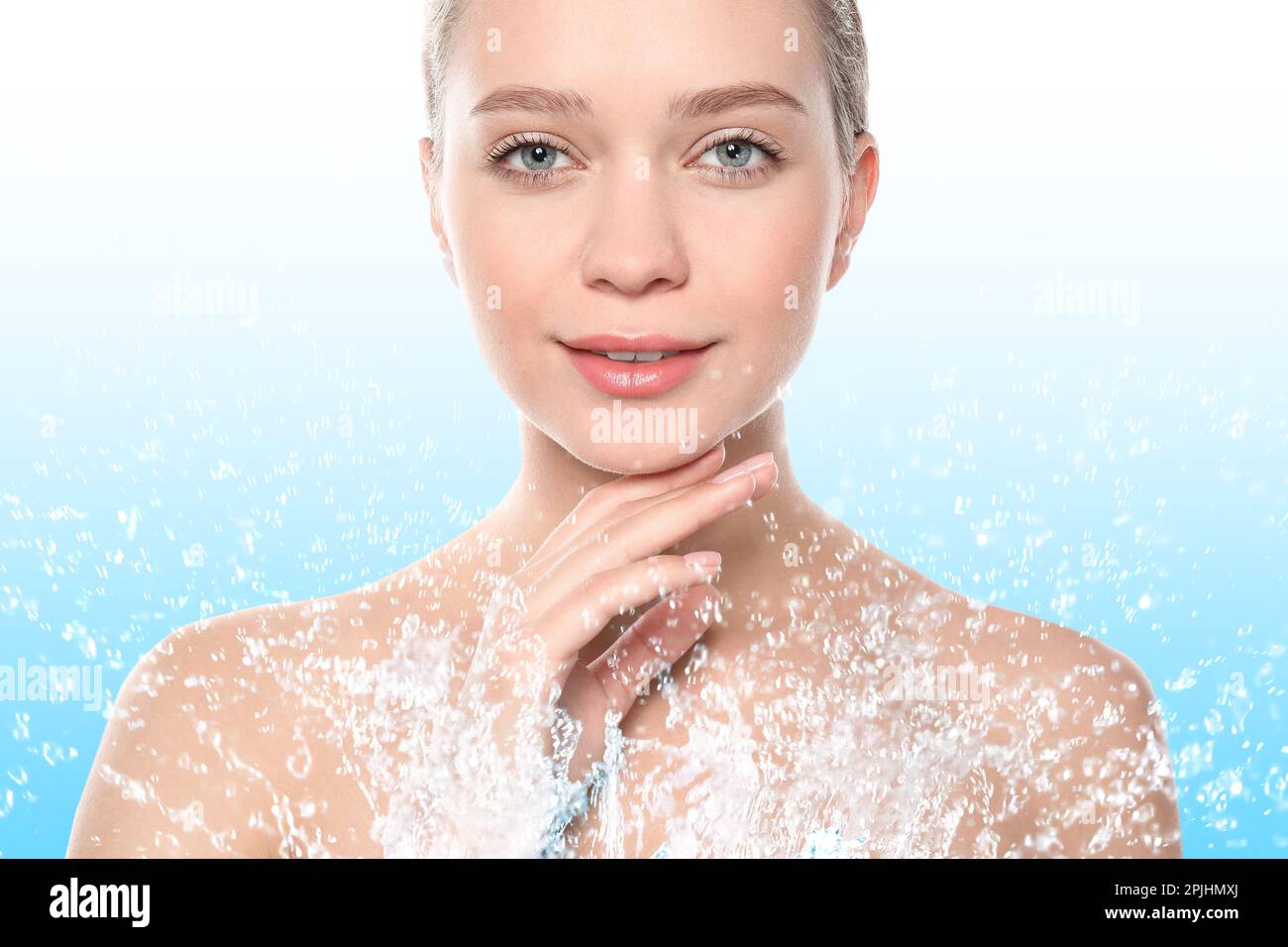 Portrait of beautiful young woman with perfect moisturized skin and ...