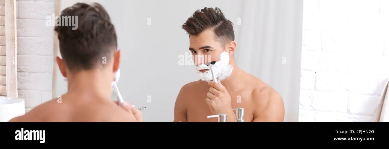 Young man shaving near mirror in bathroom. Banner design Stock Photo ...