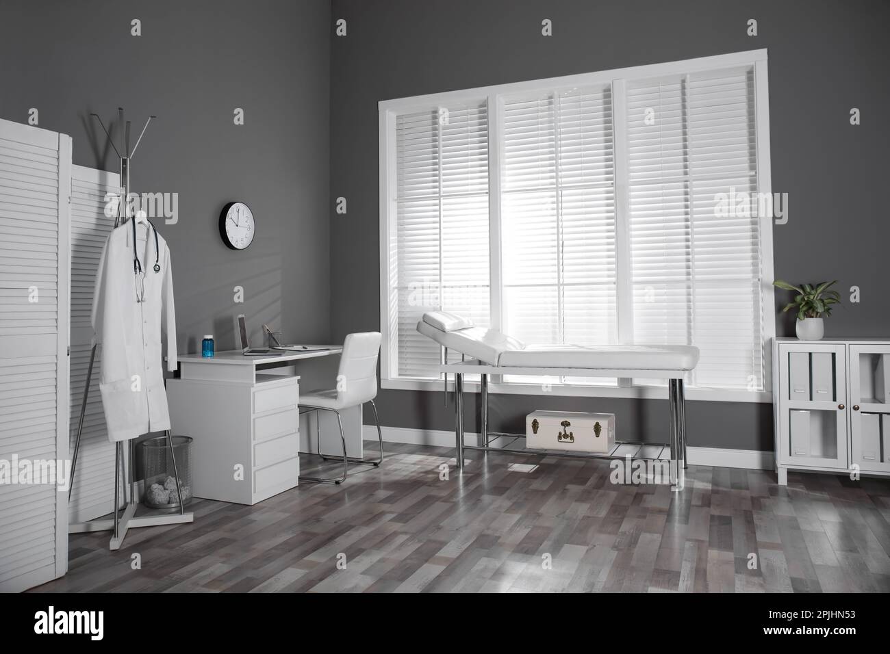 Modern medical office interior with doctor's workplace and examination ...