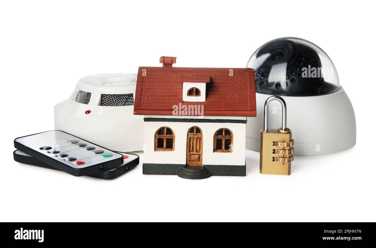 House model, CCTV camera, remote controls, lock and smoke detector on ...