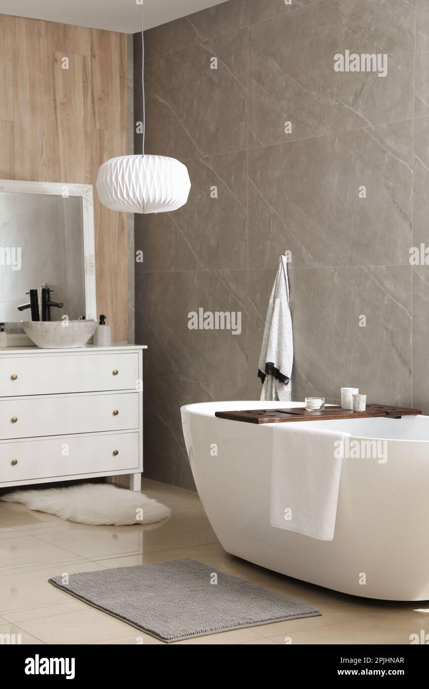 Modern white tub and chest of drawers with sink in bathroom. Interior ...