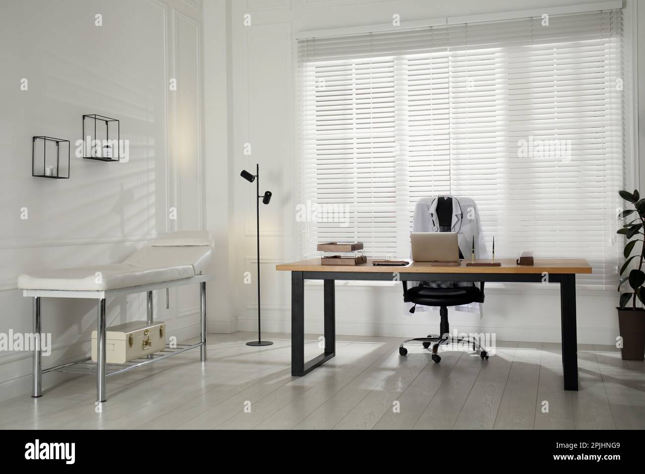 Modern medical office interior with doctor's workplace and examination ...