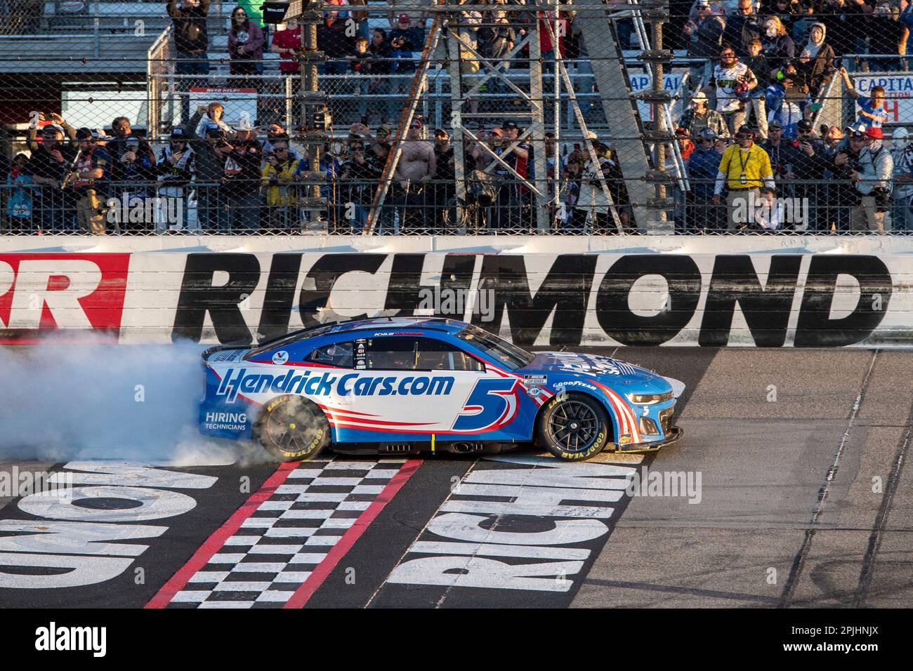 Kyle Larson (5) celebrates by doing a burnout after winning a NASCAR ...