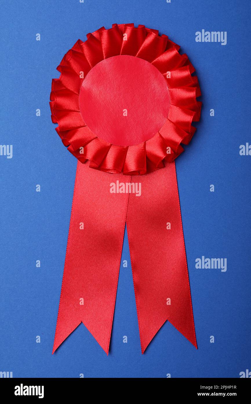 Red award ribbon on blue background, top view Stock Photo - Alamy