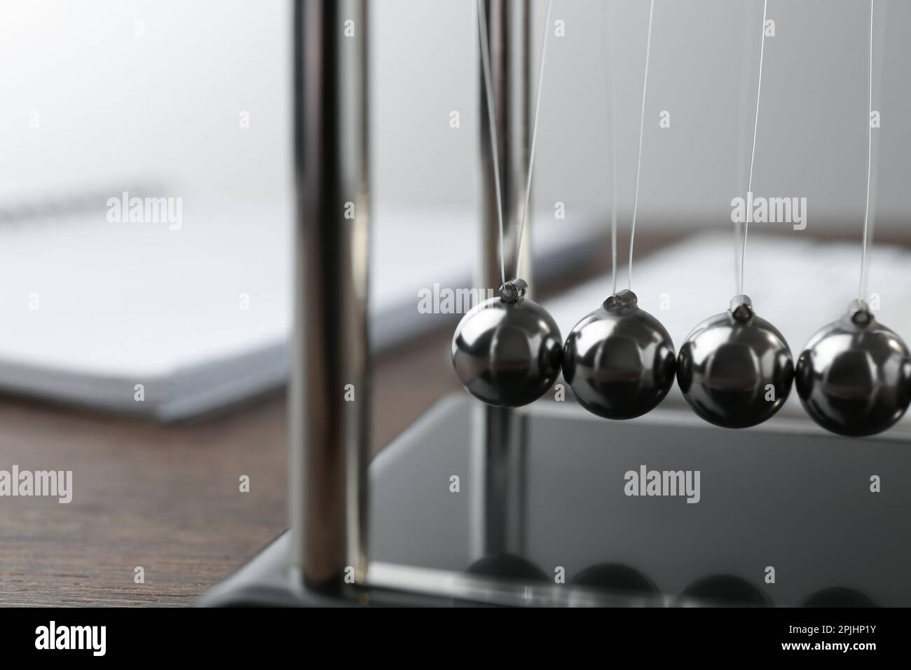 Perpetual motion pendulum office toy hi-res stock photography and ...