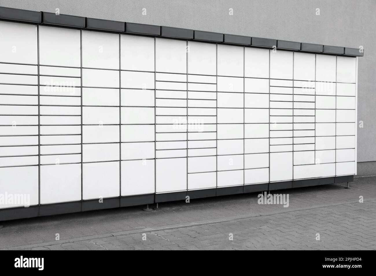 Modern parcel locker with many postal boxes outdoors Stock Photo - Alamy