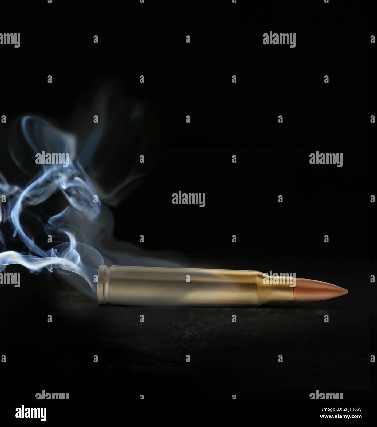 One bullet with smoke on black background Stock Photo - Alamy