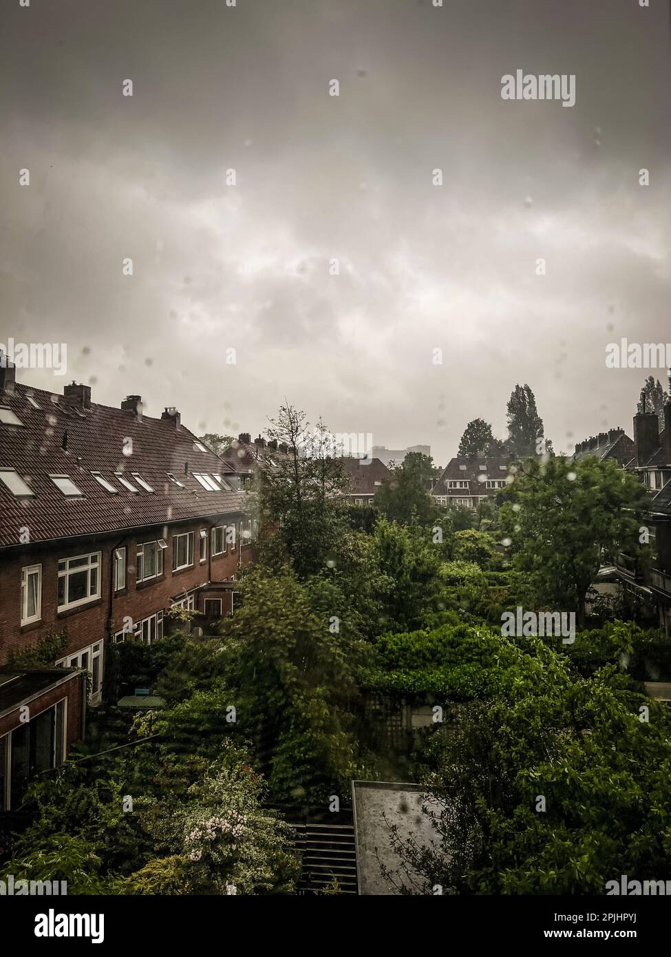 Beautiful cityscape with residential buildings on rainy day, view from ...