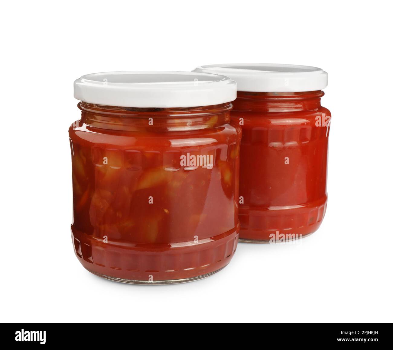 Glass jars of delicious canned lecho on white background Stock Photo ...