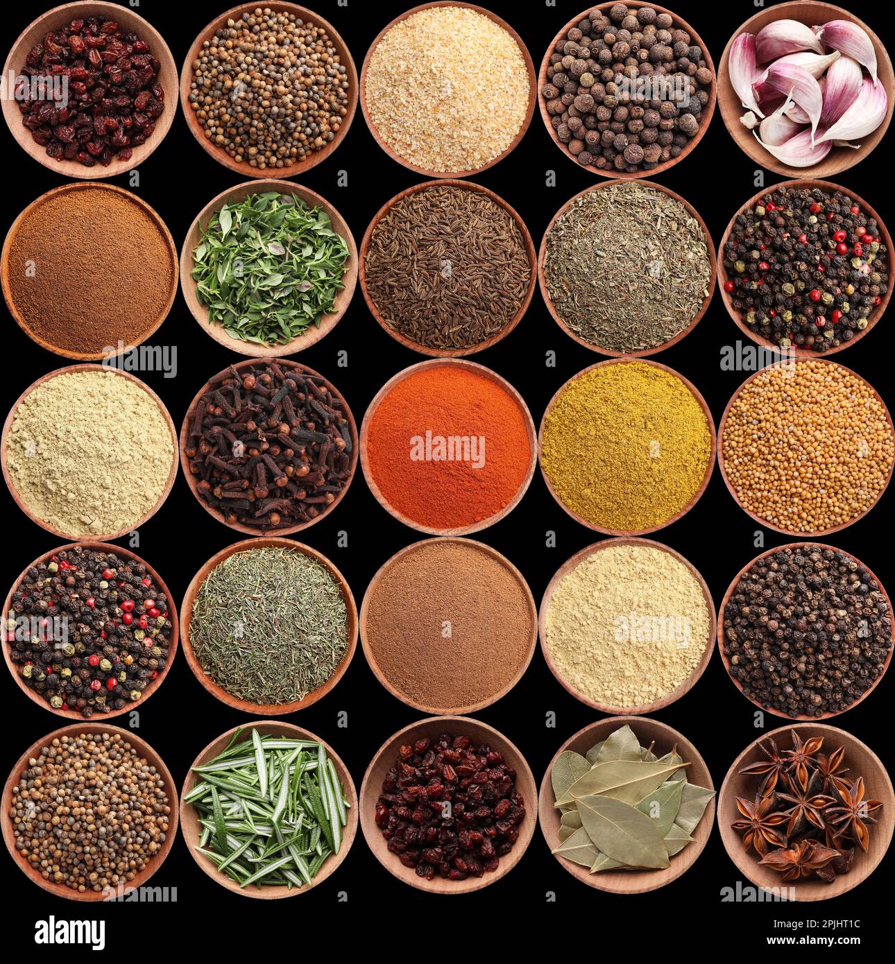 Collection of different aromatic spices and herbs on black background ...