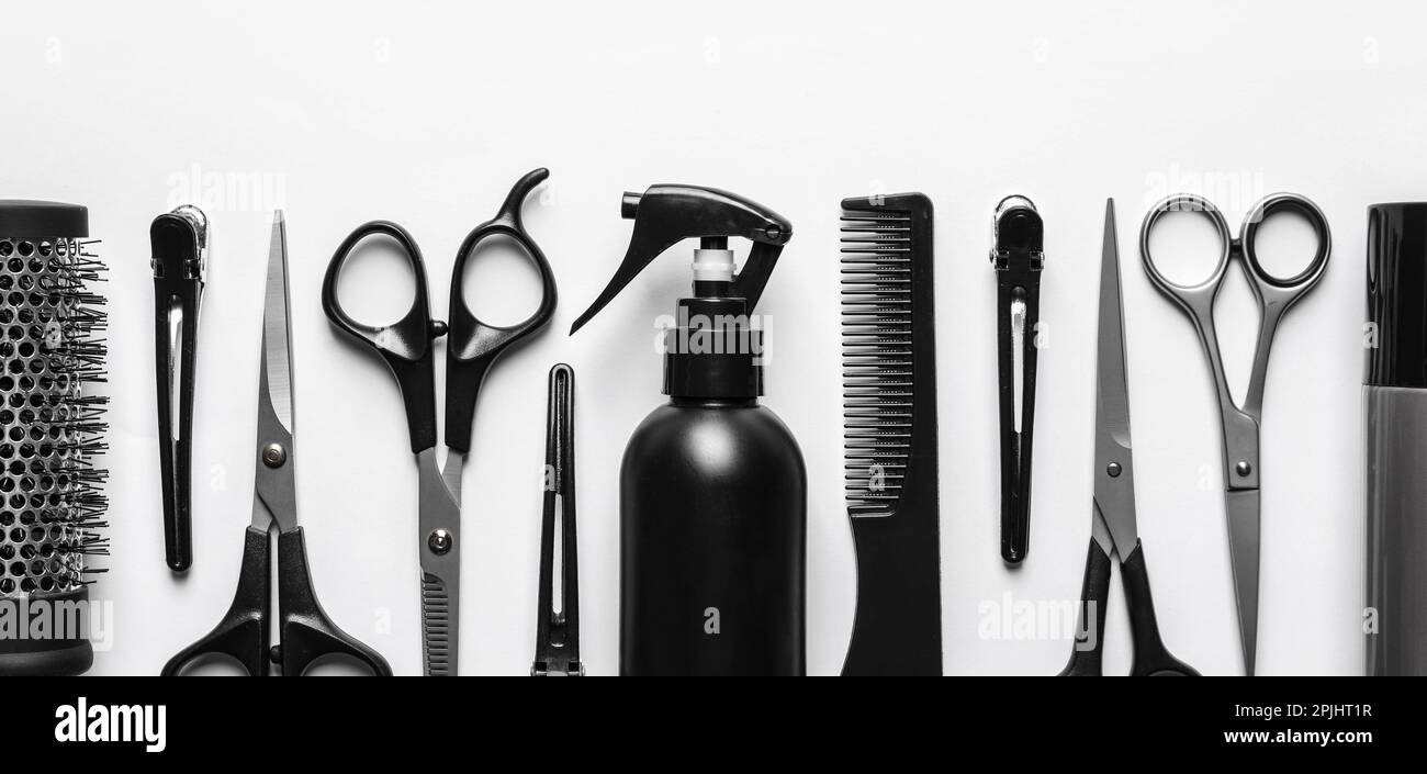 Set with scissors and other hairdresser's accessories on white ...