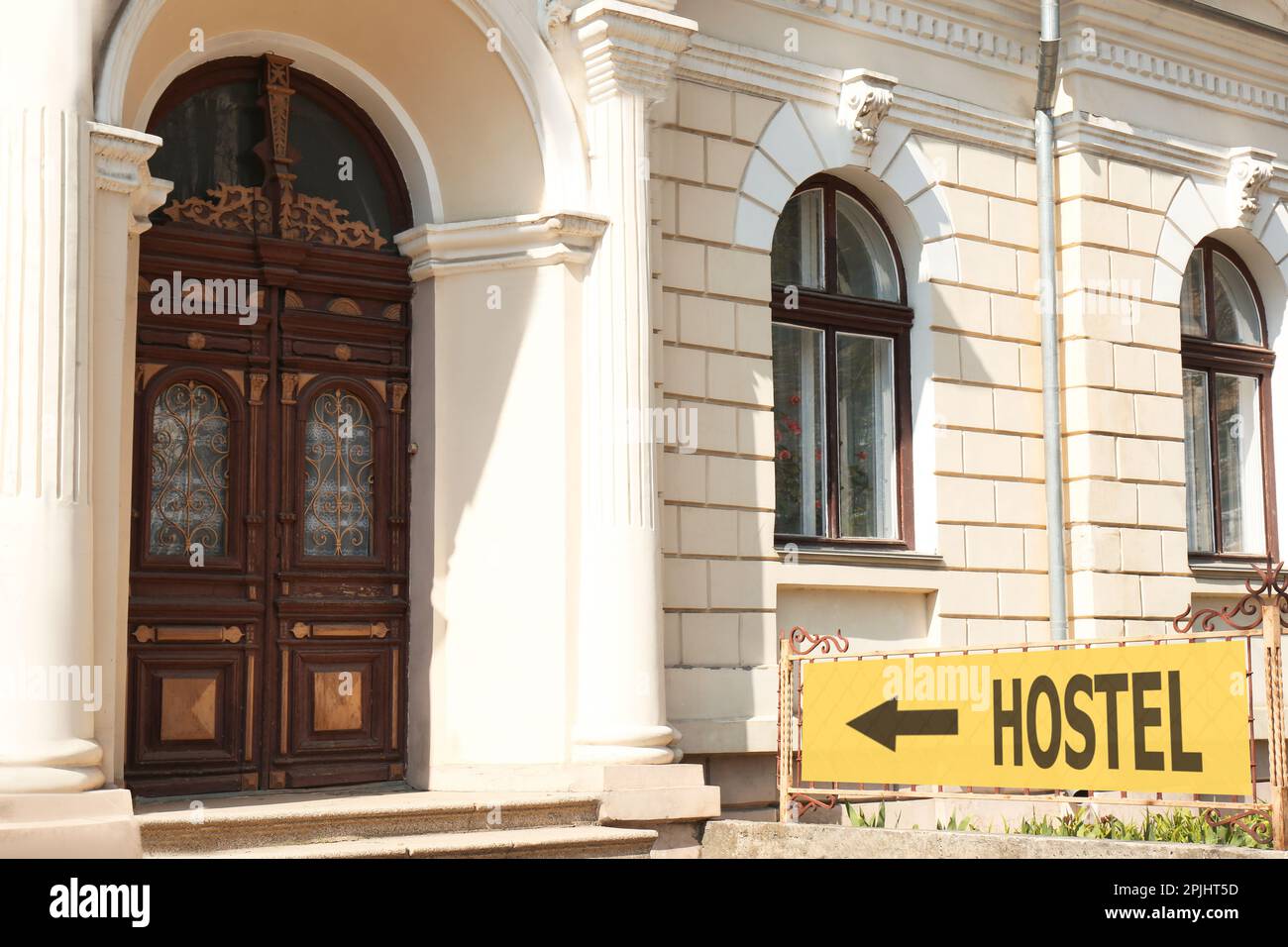 HOSTEL sign board with arrow near old building outdoors Stock Photo - Alamy