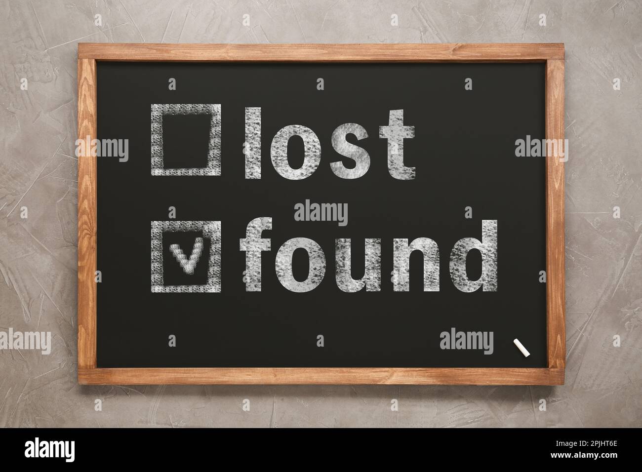 Words Lost and Found written on blackboard on grey background, top view ...