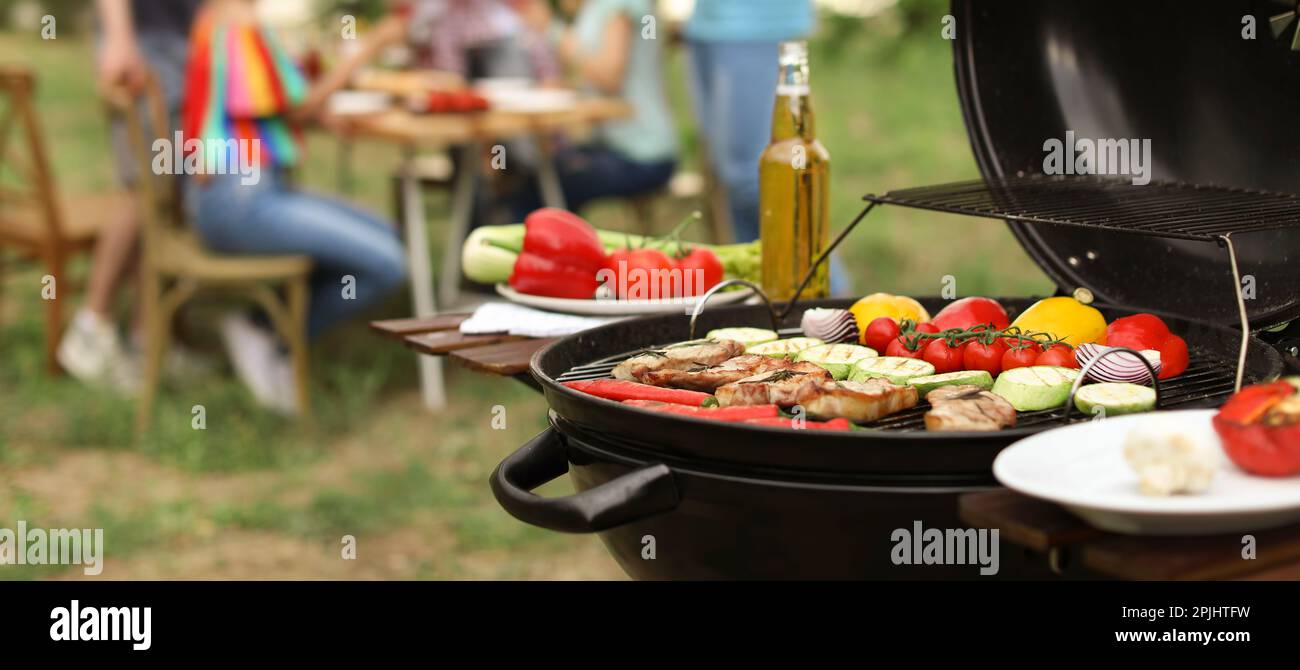 Modern grill with meat and vegetables outdoors, closeup. Banner design ...