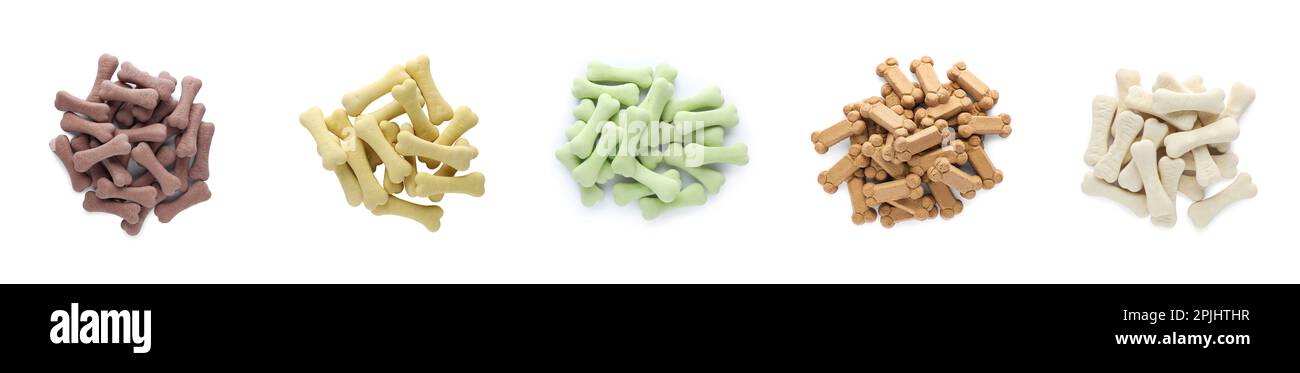 Set with piles of different bone shaped dog cookies on white background ...