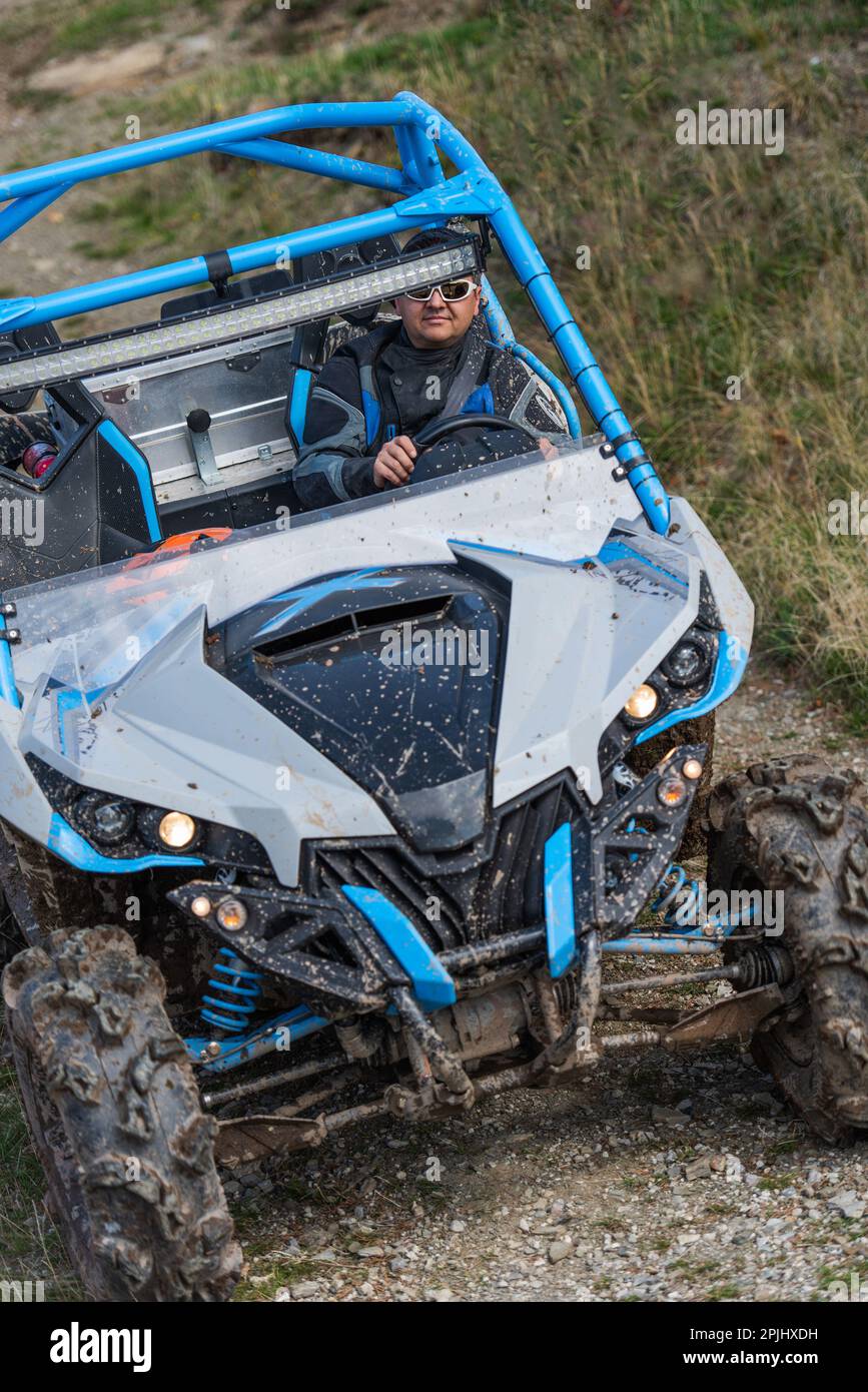 Adventurous driving of ATV motorbikes. A man drives a quad bike on ...