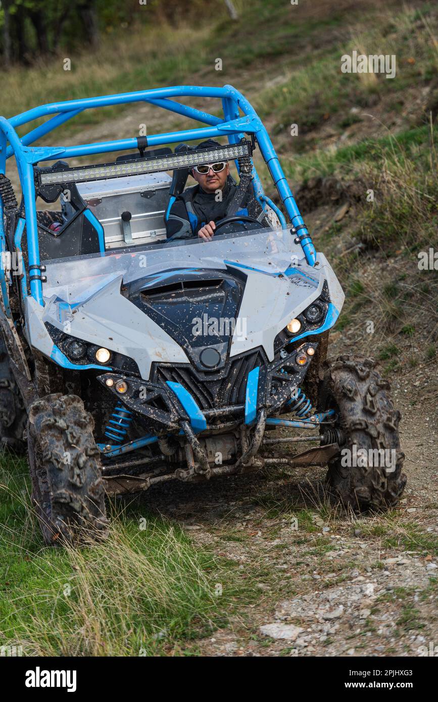Adventurous driving of ATV motorbikes. A man drives a quad bike on ...