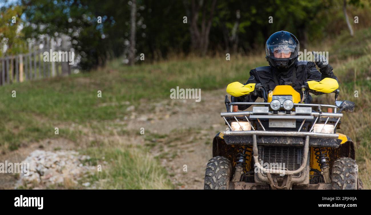 Adventurous driving of ATV motorbikes. A man drives a quad bike on ...