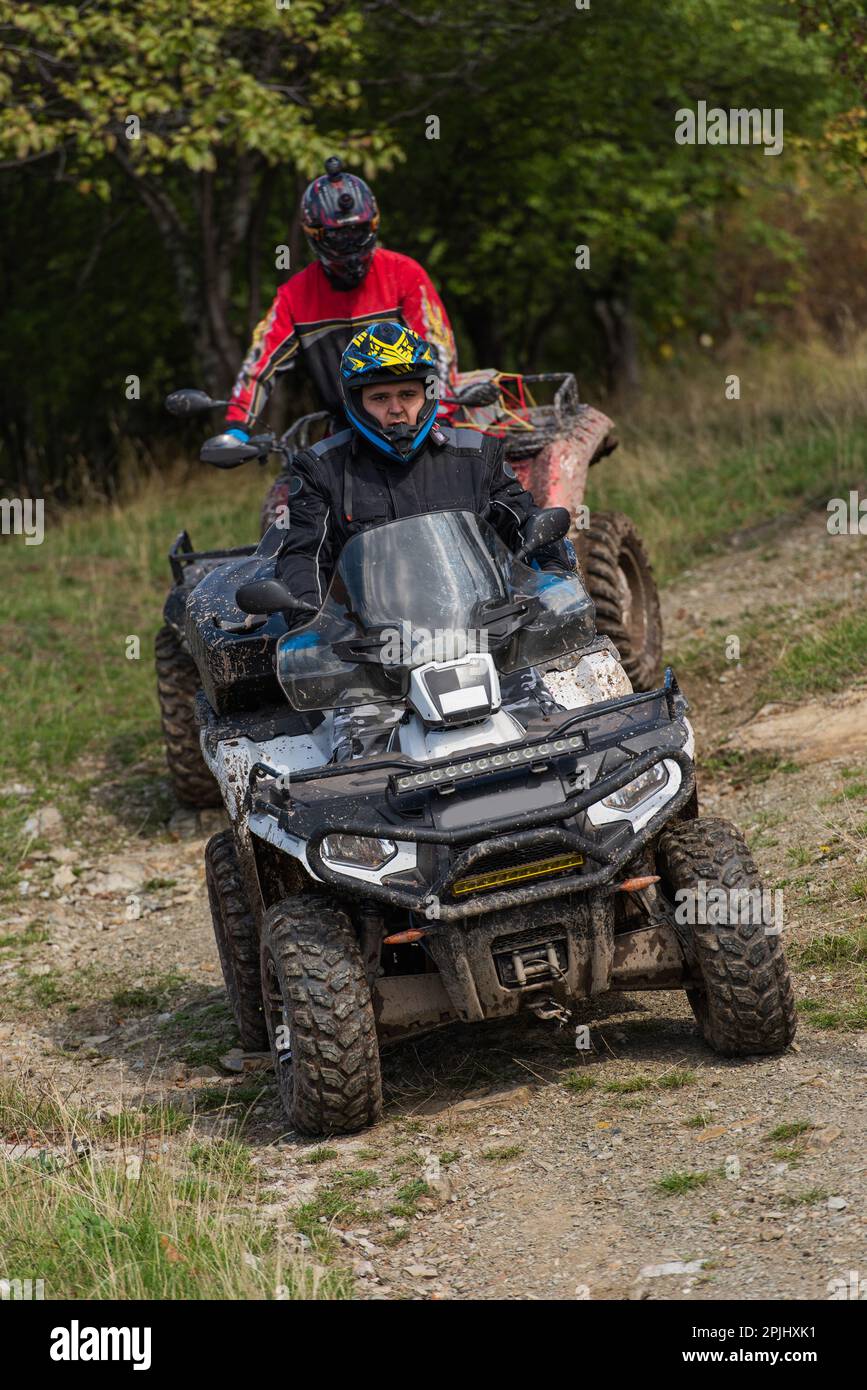 Adventurous driving of ATV motorbikes. A man drives a quad bike on ...