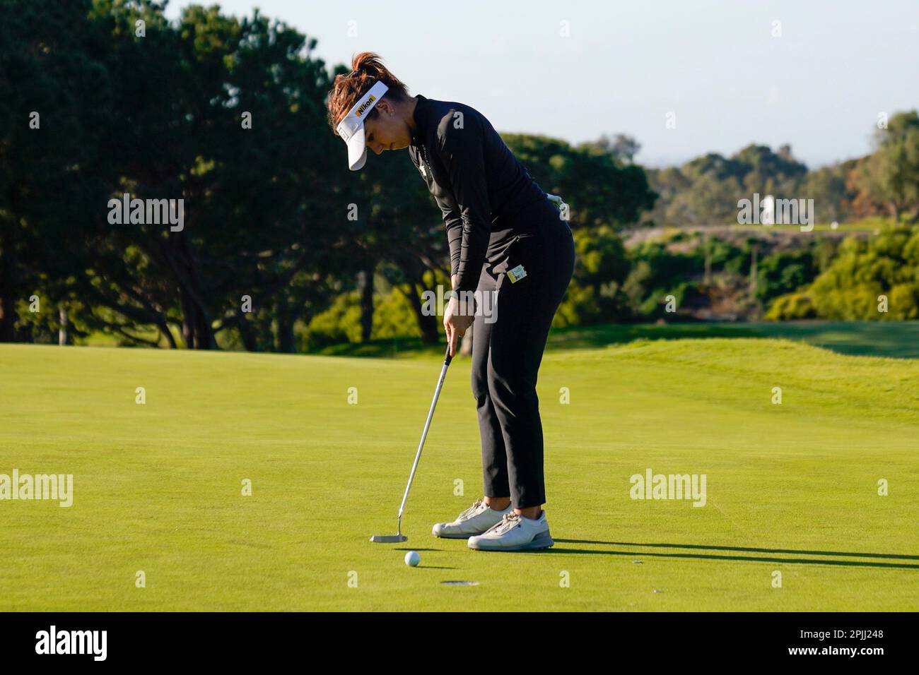 Georgia Hall putts on the 18th green during the final round of LPGA's ...