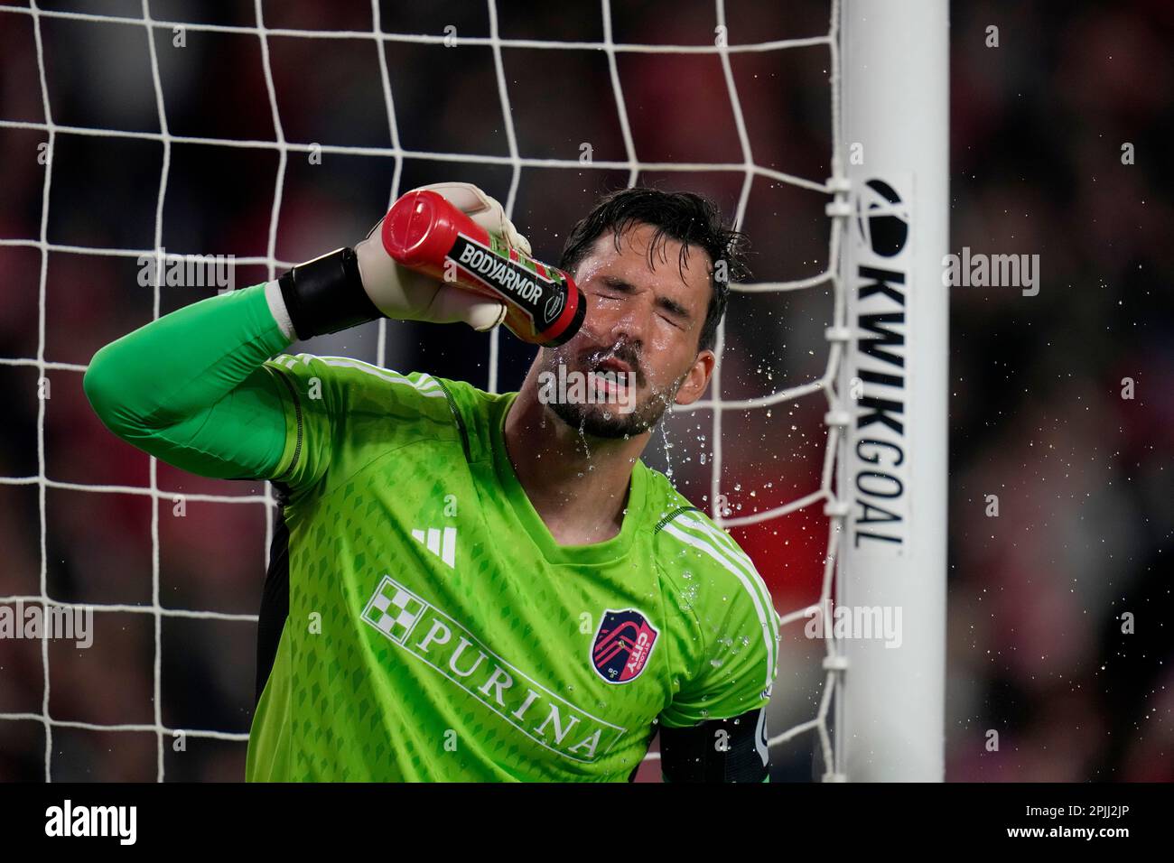 St. Louis City goalkeeper Roman Burki sprays his face during the first ...