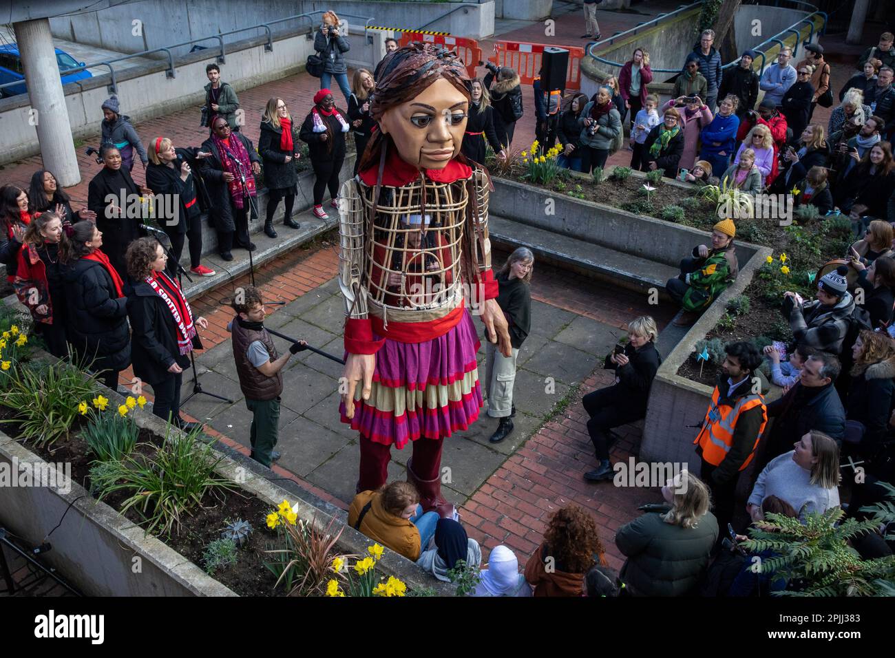 London, UK. 2nd April, 2023. A crowd of people accompanies Little Amal ...