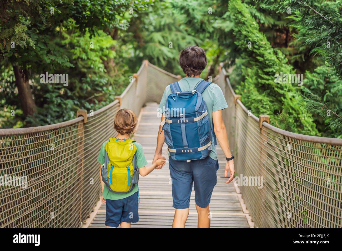 father and son tourists in Rope bridge in Yildiz Park. Besiktas ...