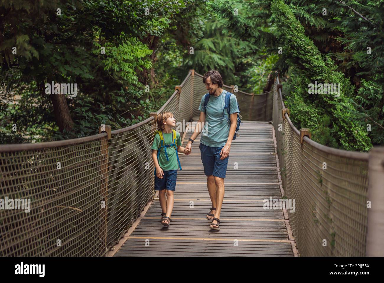 father and son tourists in Rope bridge in Yildiz Park. Besiktas ...