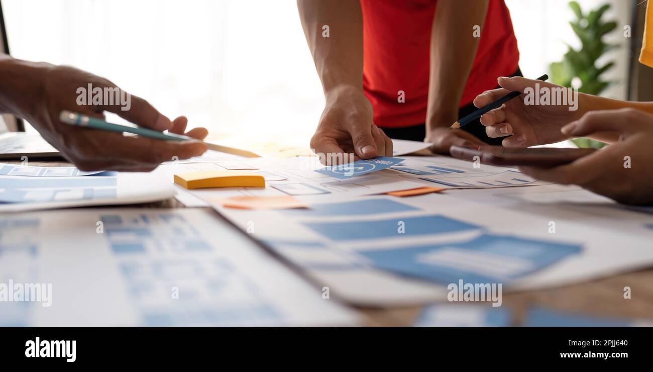 Close up ux developer and ui designer brainstorming about mobile app ...