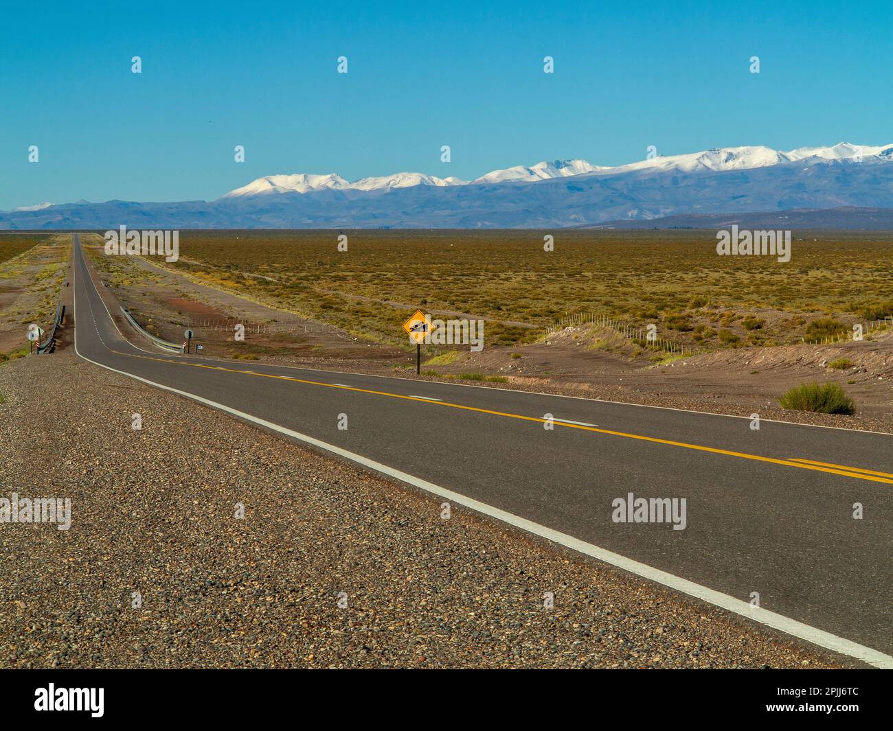 Snow of the Andes mountains in the distance, as seen from the Ruta 40 ...