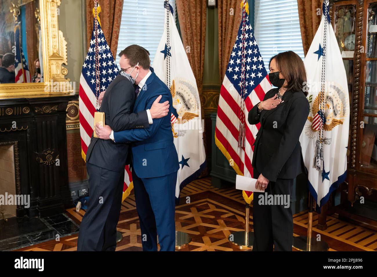 Vice President Kamala Harris looks on as Pete Buttigieg embraces his ...