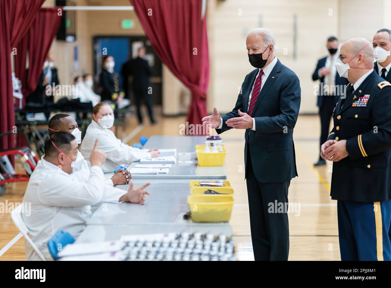 President Joe Biden, joined by U.S. Army Col. Andrew Barr, talks with ...
