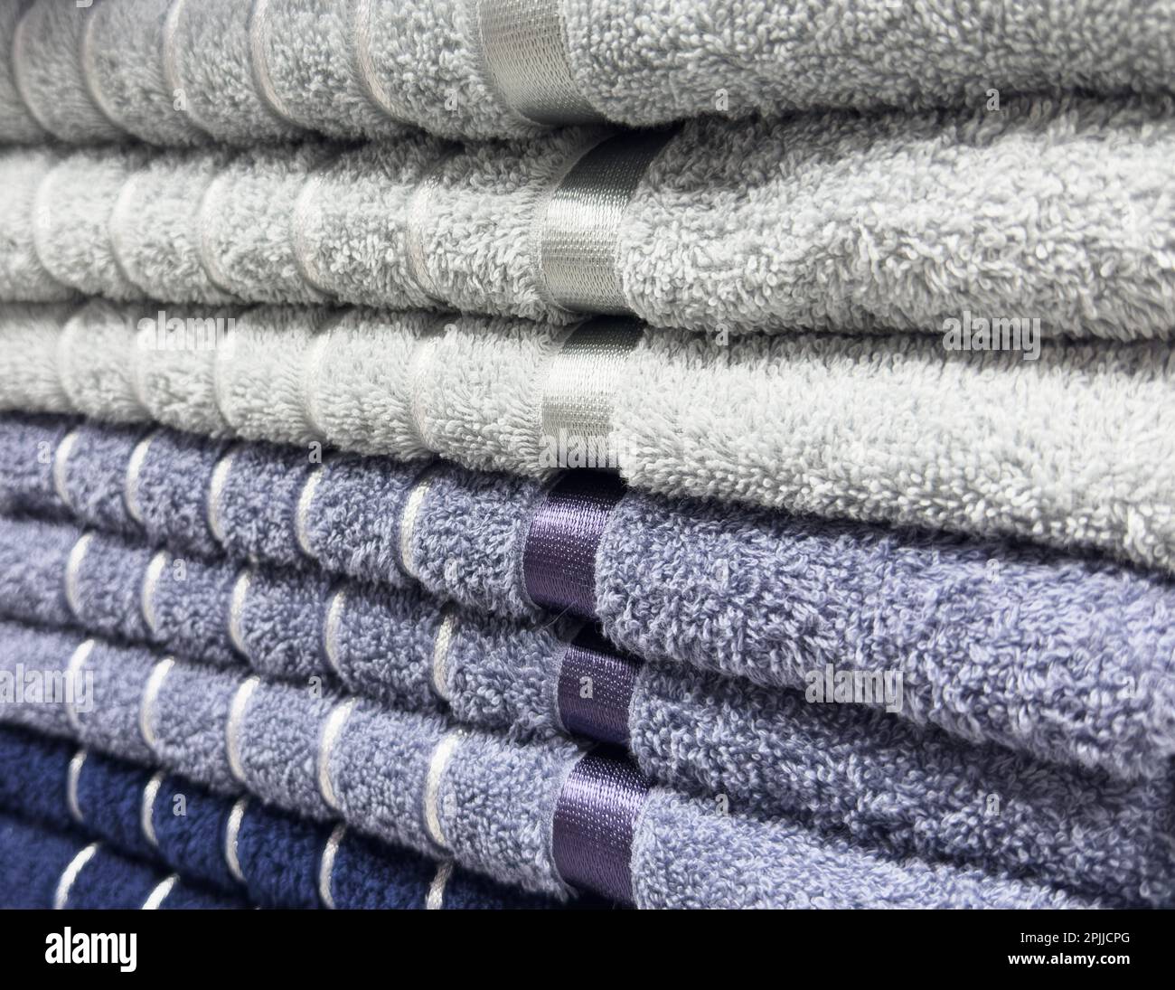 Stack of colorful towels. Fresh new fluffy towels. Pile stacked colored ...