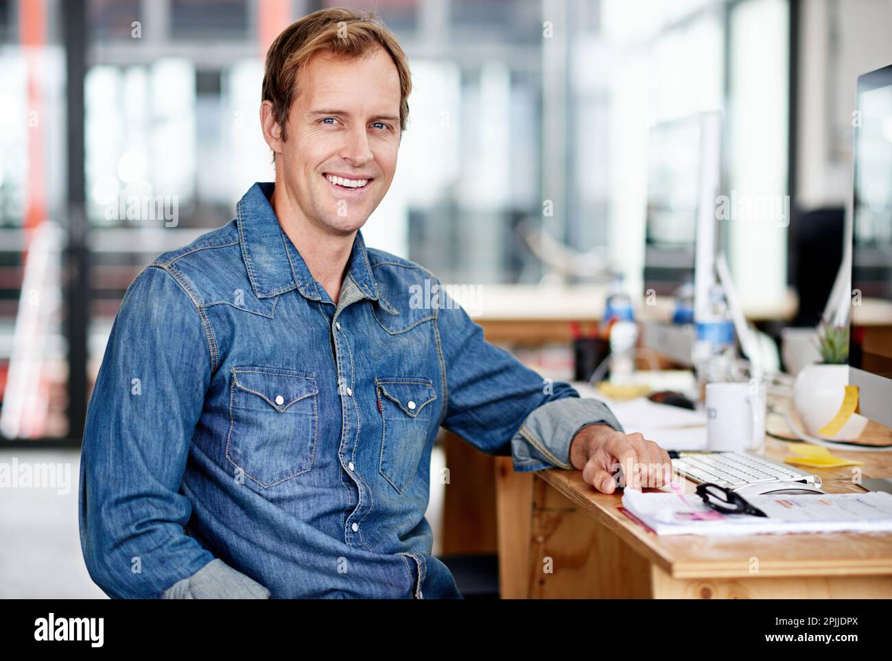 All the magic happens at my workstation. Portrait of a designer sitting ...