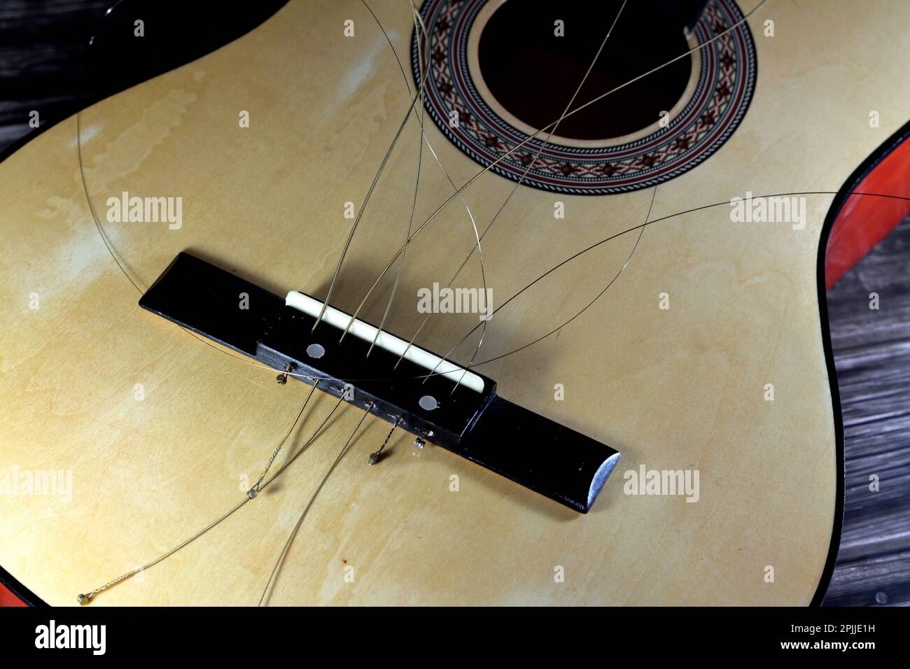 A broken wooden old classic guitar with damaged strings chords ...