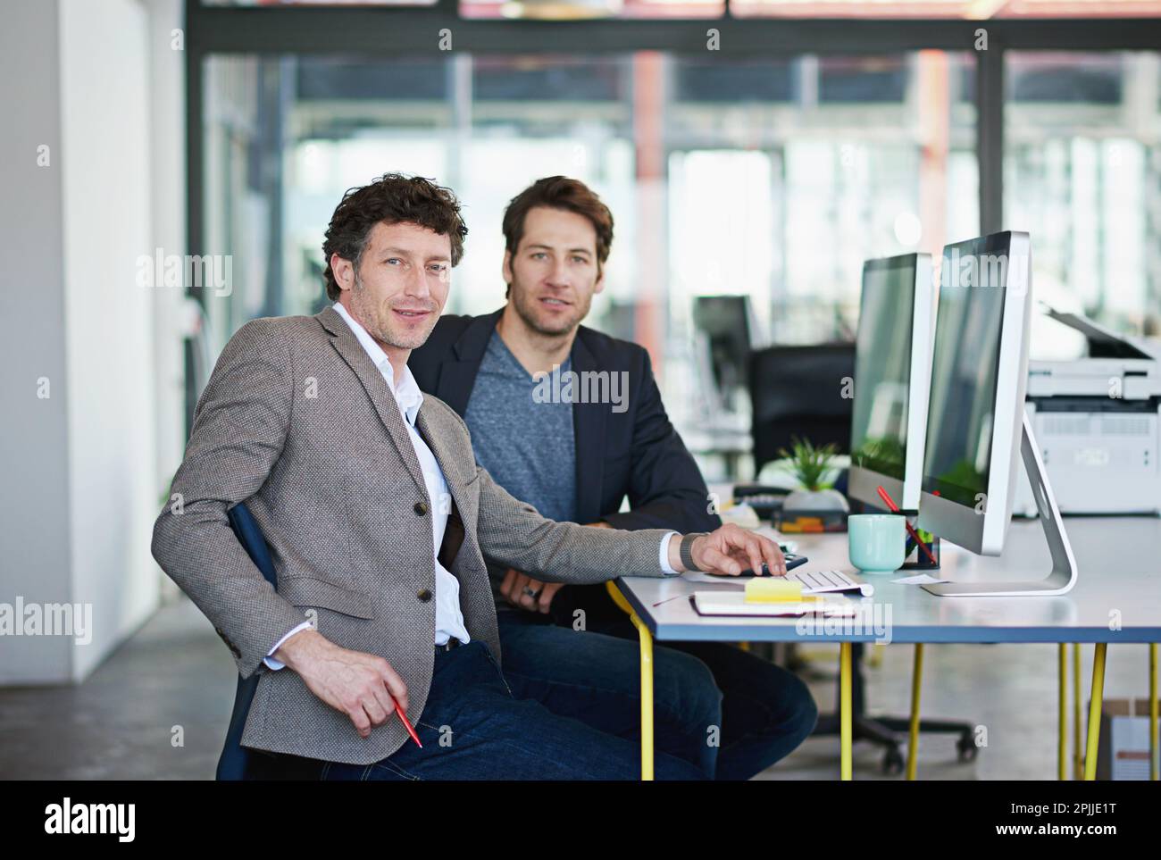 Design is in our blood. Portrait of two people working together in a ...