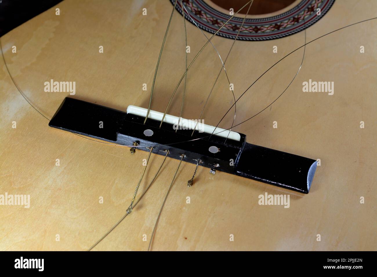 A broken wooden old classic guitar with damaged strings chords ...