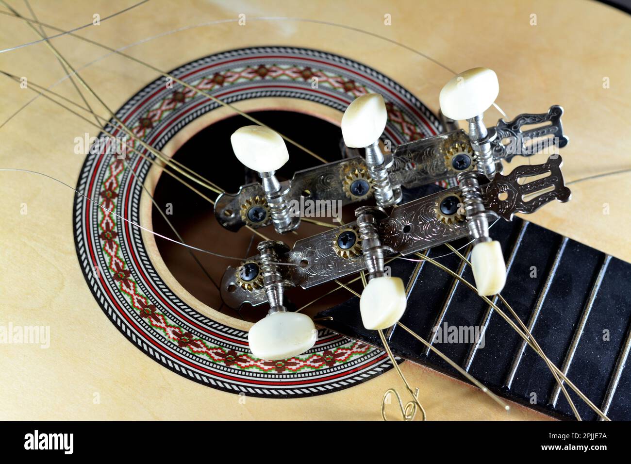 A broken wooden old classic guitar with damaged strings chords ...