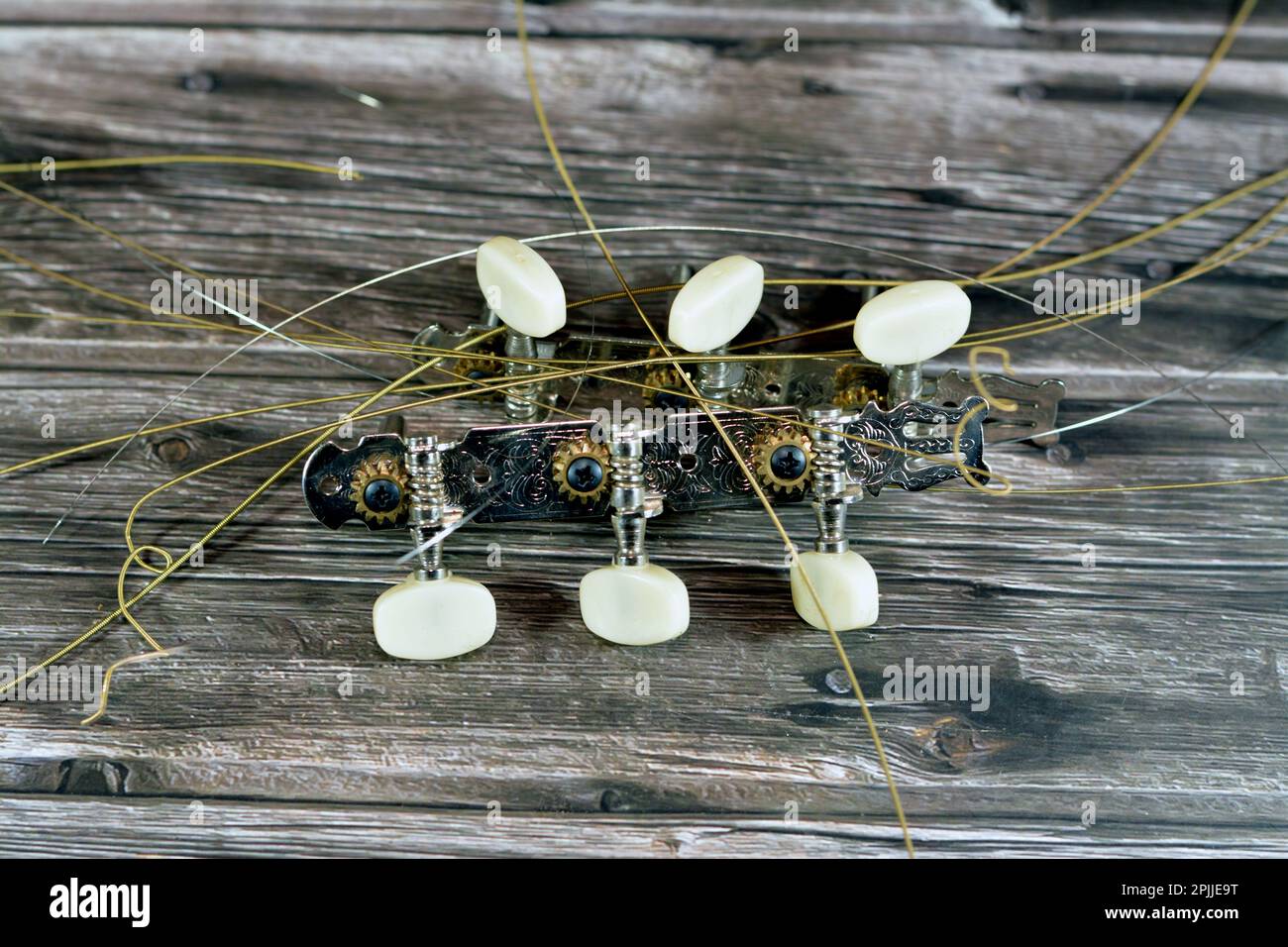 A broken wooden old classic guitar with damaged strings chords ...
