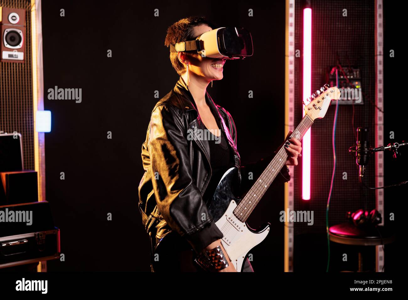 Rebel rockstar playing heavy metal song using electric guitar while ...