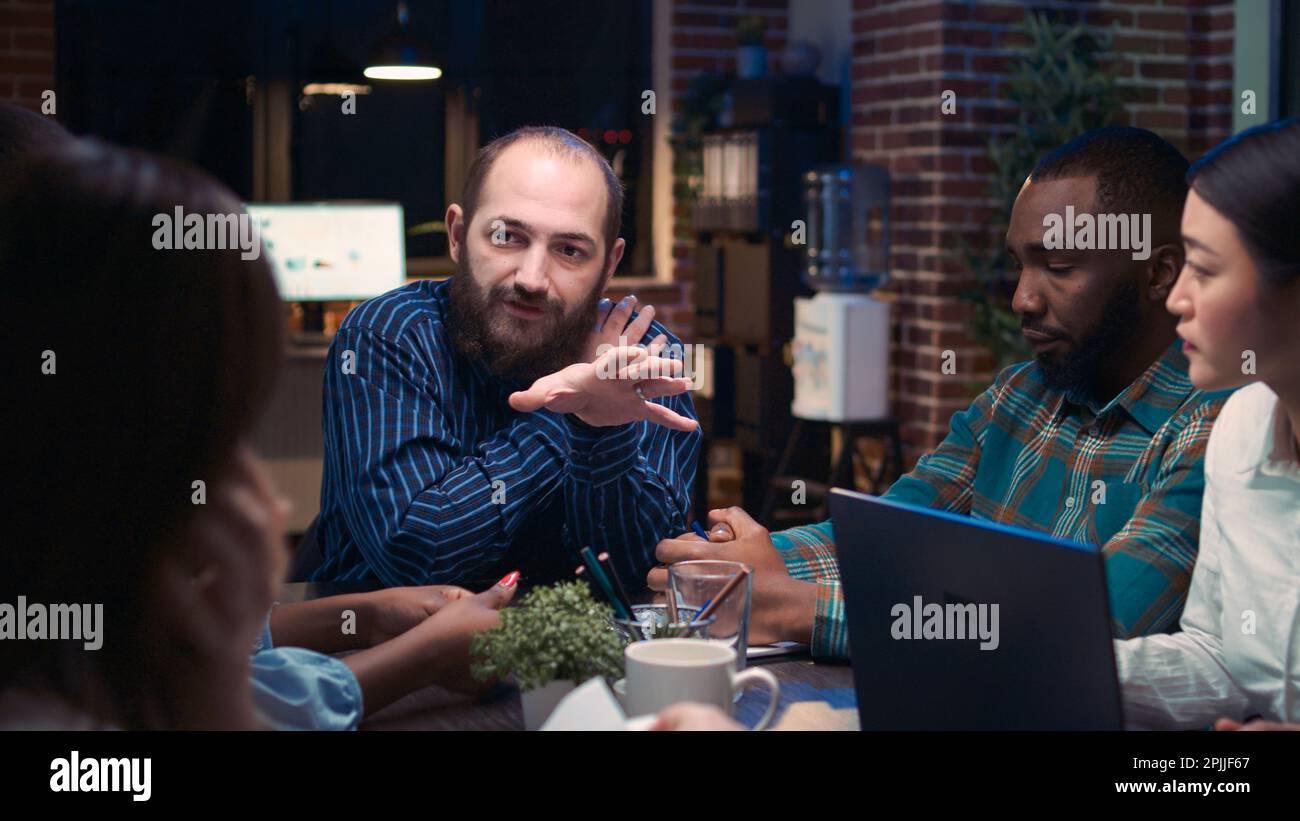 Diverse coworkers brainstorming in business meeting, discussing presentation, team communication ...