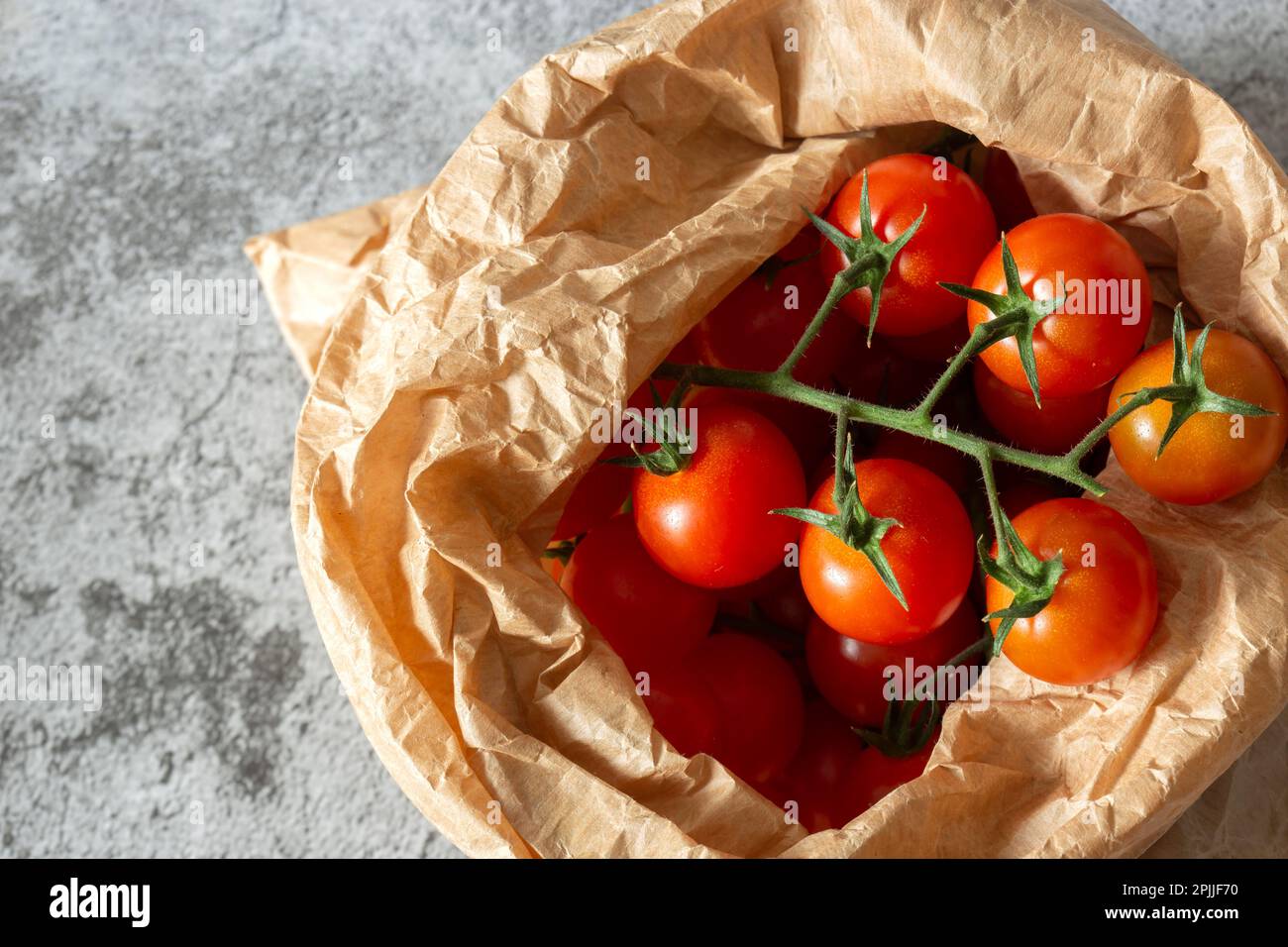 Cherry tomatoes in a brown paper bag. Eco friendly sustainable ...