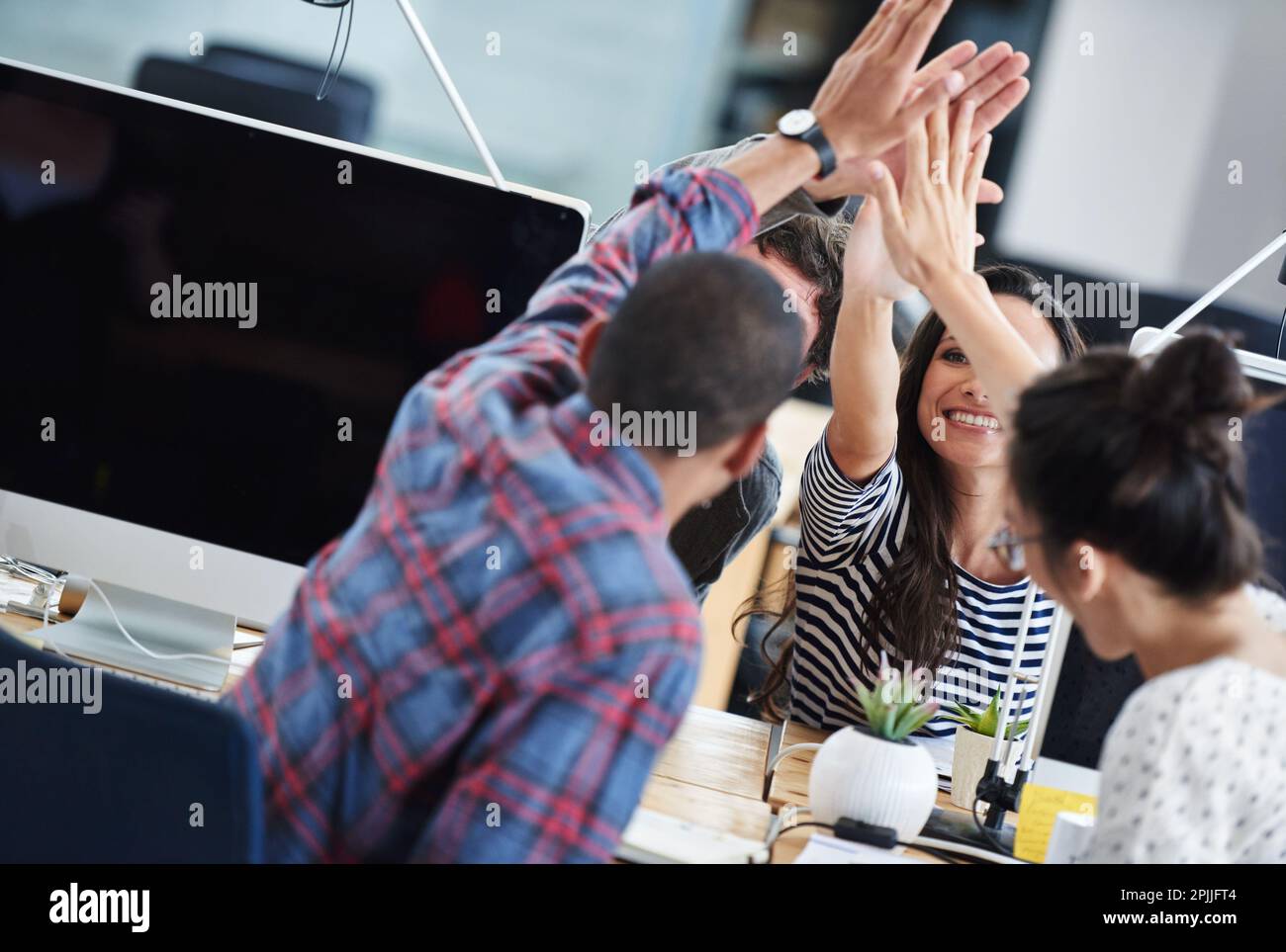 Make creativity a job. a group of young office workers sitting at their ...