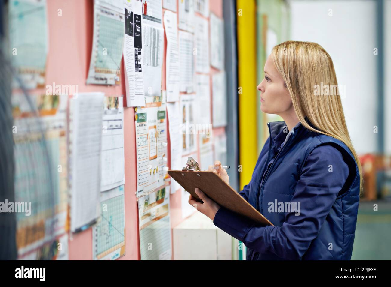 Checking logistics. a woman at work in a storage warehouse Stock Photo ...