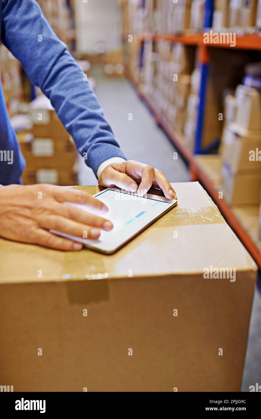 Digital inventory made easy. a man using a digital tablet while working ...