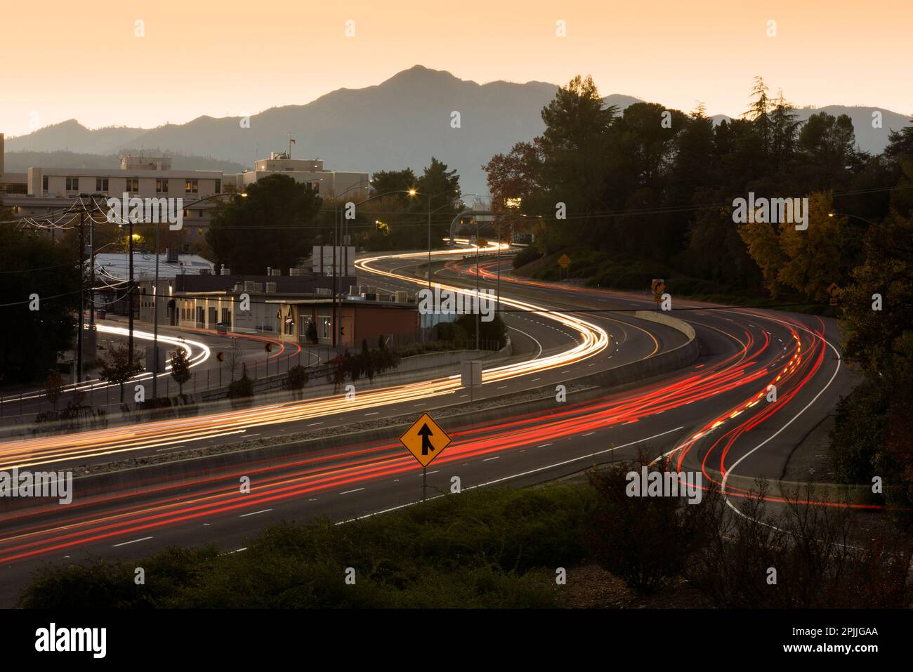 Sunset traffic passes on CA-44 through downtown Redding, California ...